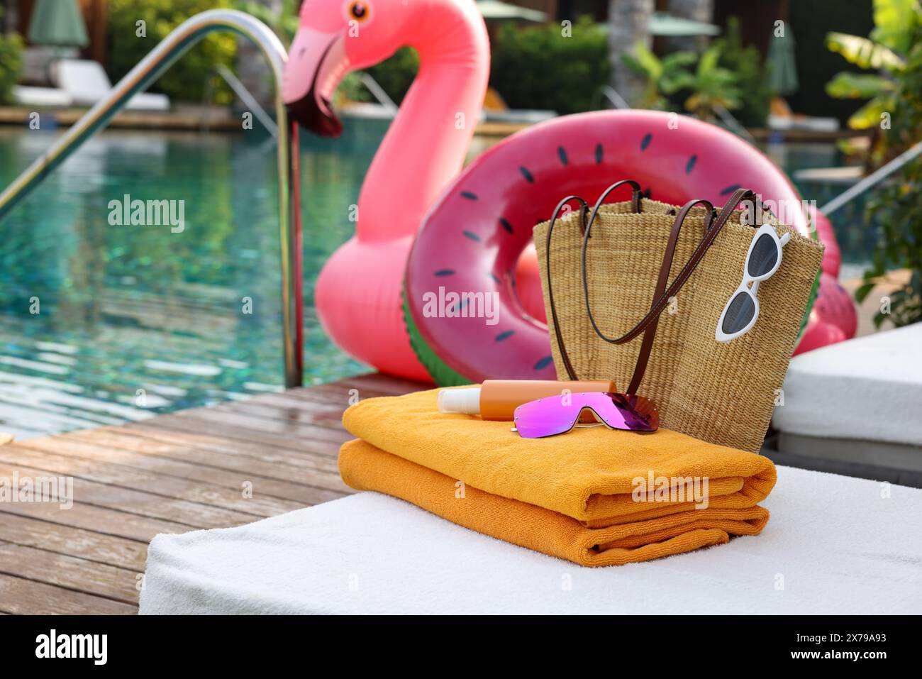 Beach accessories on sun lounger, inflatable ring and float near ...