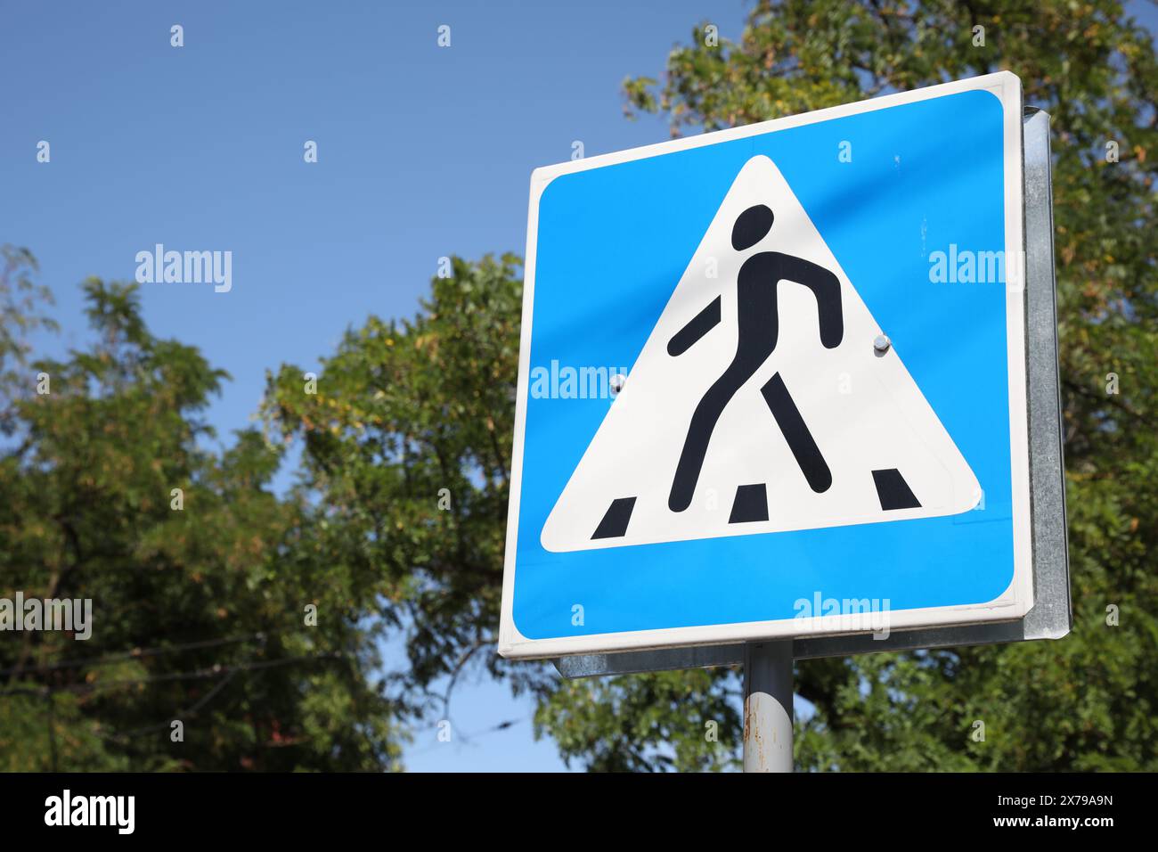 Pedestrian crossing road sign outdoors on sunny day Stock Photo - Alamy