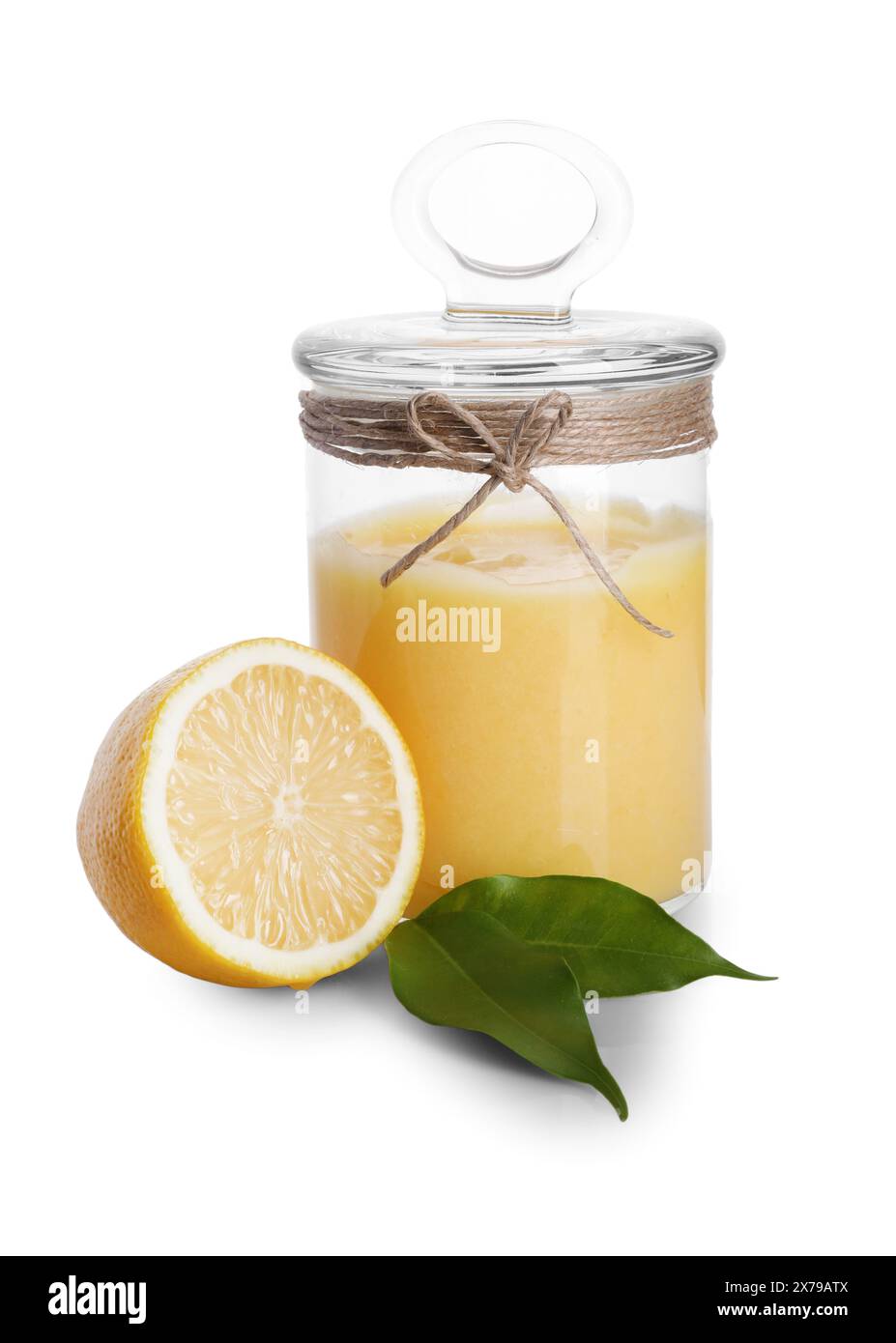 Delicious lemon curd in glass jar, fresh citrus fruit and green leaves ...