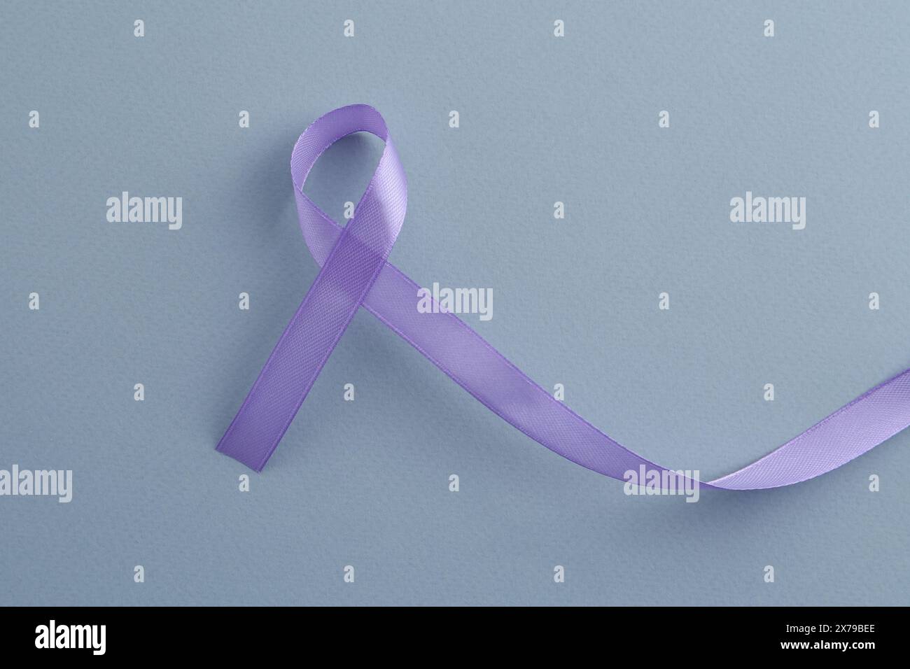 Violet awareness ribbon on light blue background, top view Stock Photo ...