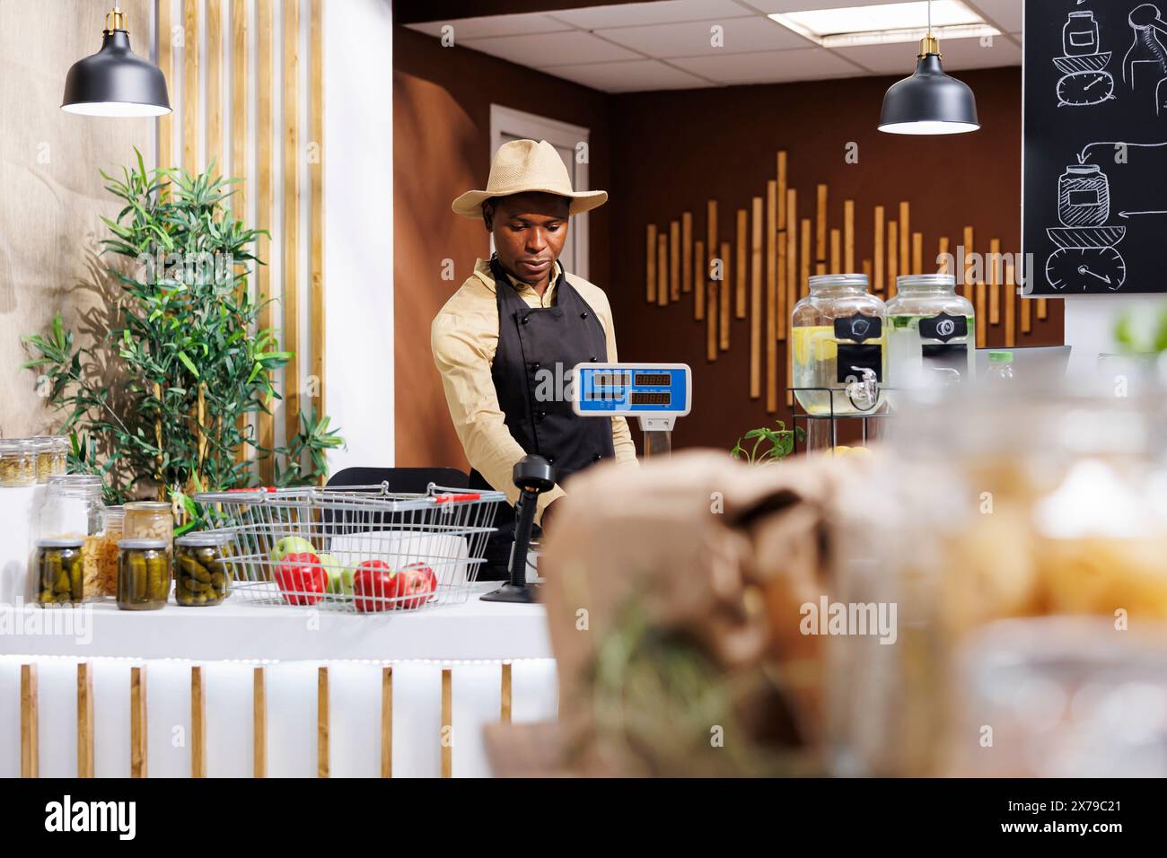 Focus on background of african american male shopkeeper at the checkout ...