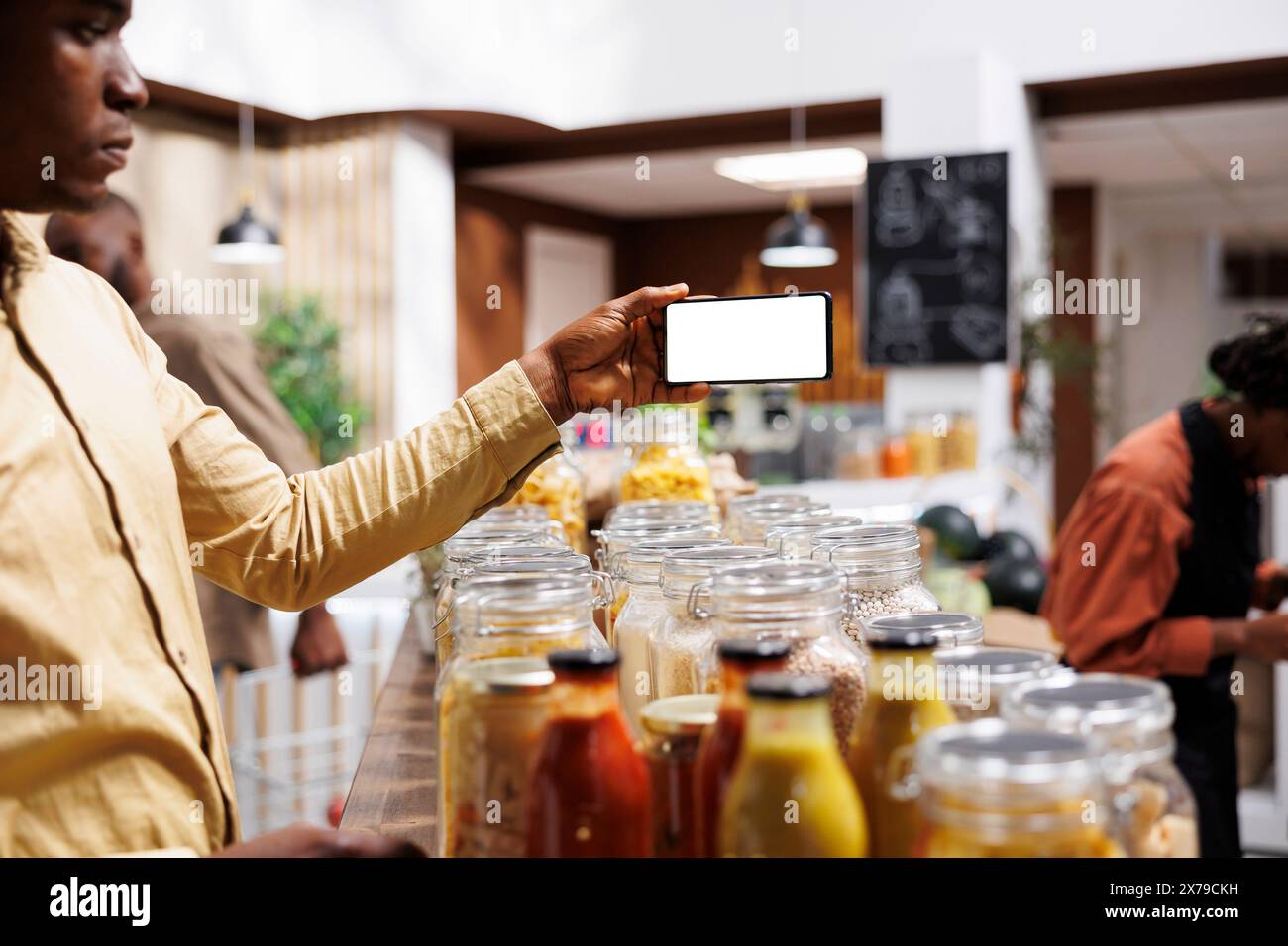 At eco friendly grocery shop African American male consumer holds a ...