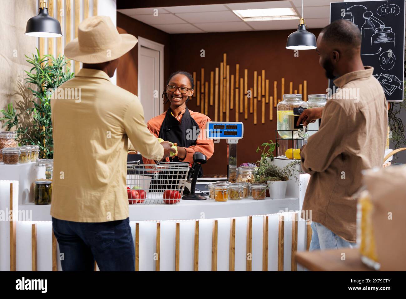 In grocery store, African American female vendor assists clients ...