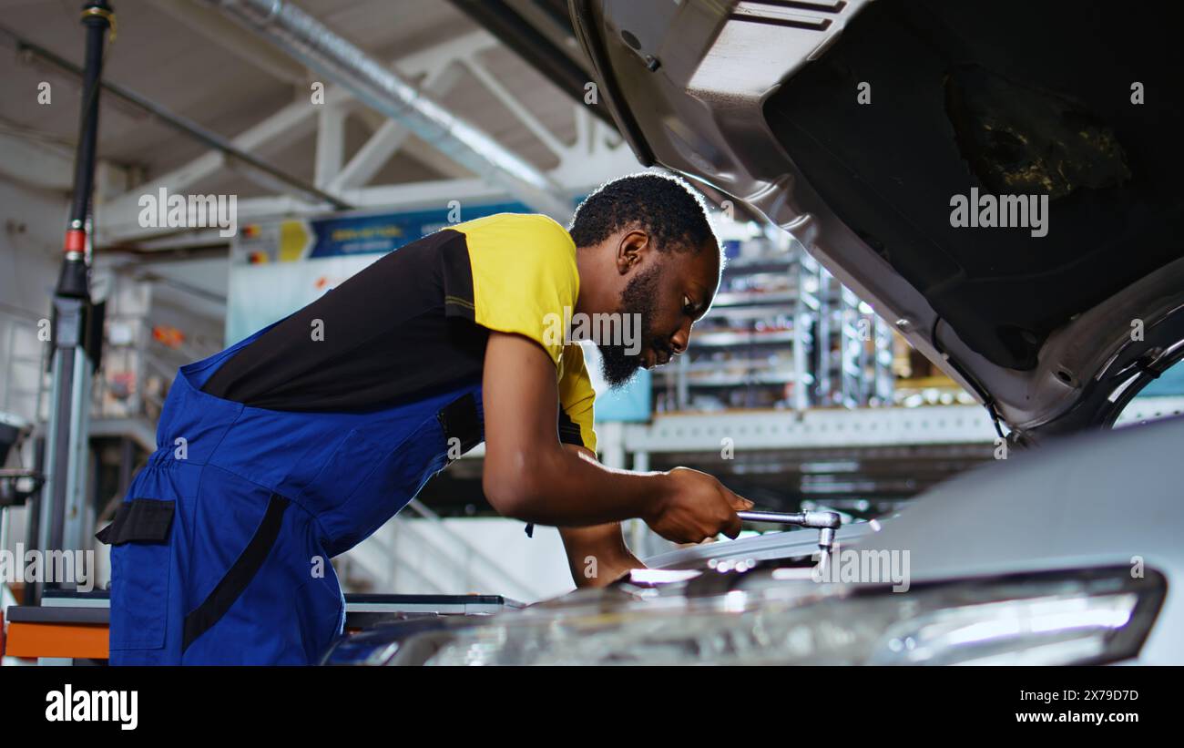 Meticulous specialist in car service picks torque wrench from work ...