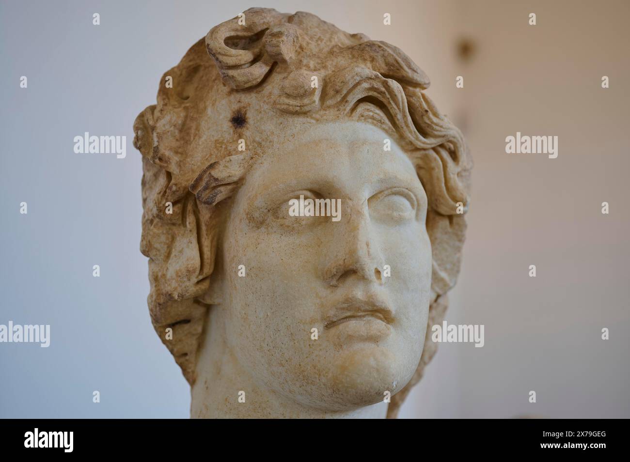 Helios, Sun God, Ancient marble sculpture of a damaged head with curly ...