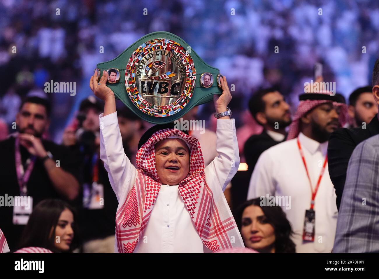 A spectator holds up a champion belt ringside at Kingdom Arena, Riyadh ...