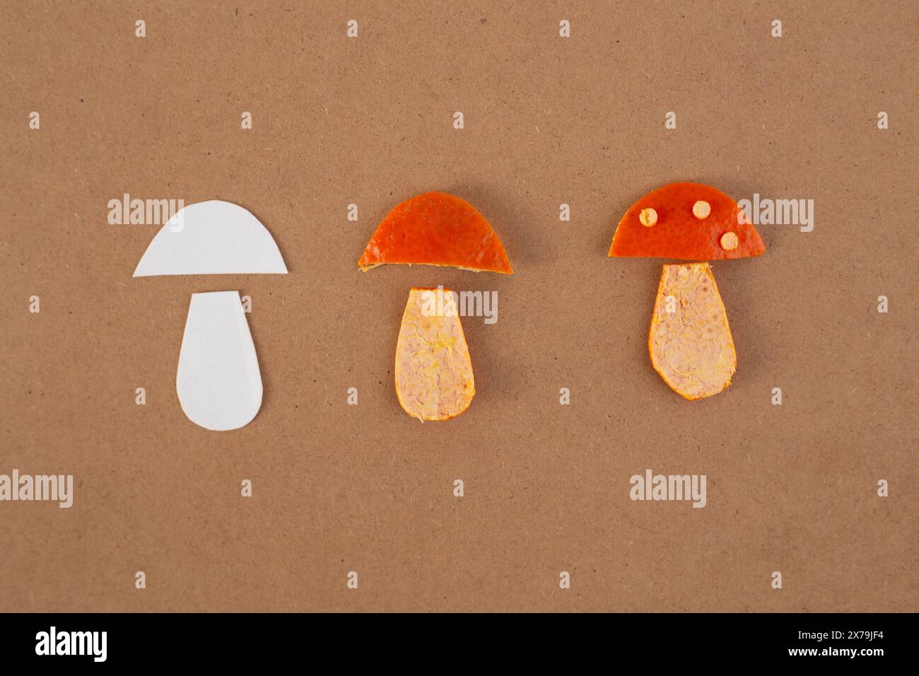 a peeled tangerine craft in shape of mushroom sitting on top of a table ...