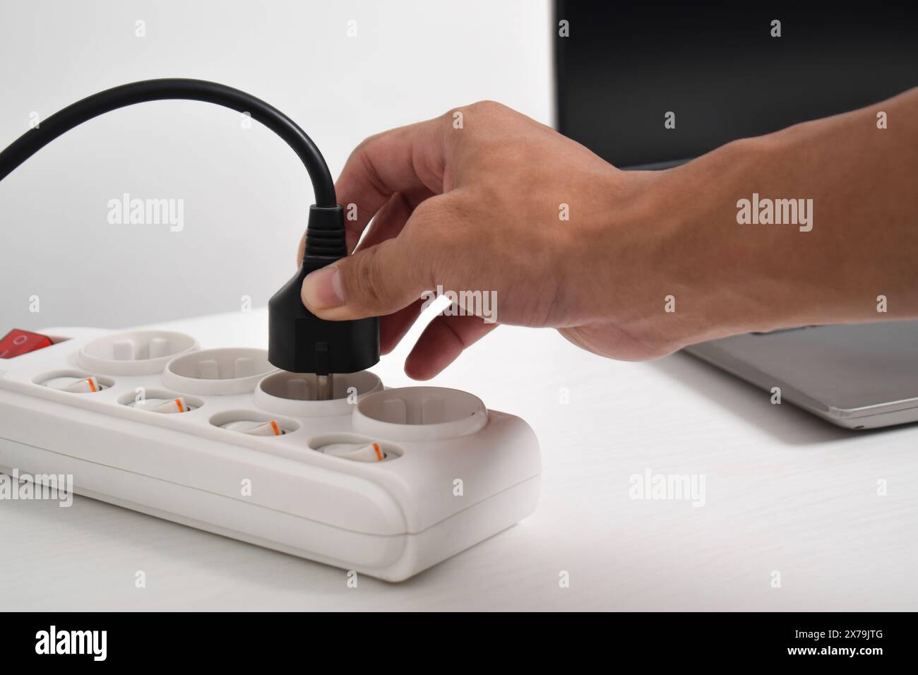 Hand holding electric plug, Multiple socket with connected plugs ...