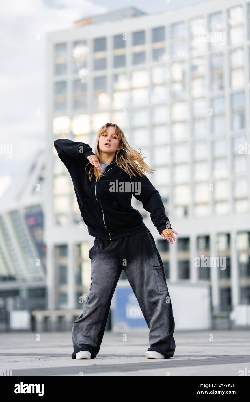 A young woman wears oversized clothes and dances hip-hop Stock Photo ...
