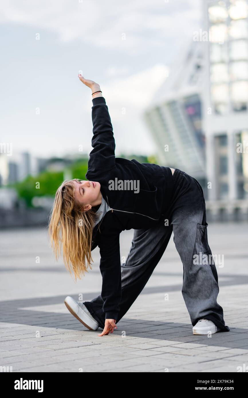 A young woman wears oversized clothes and dances hip-hop Stock Photo ...