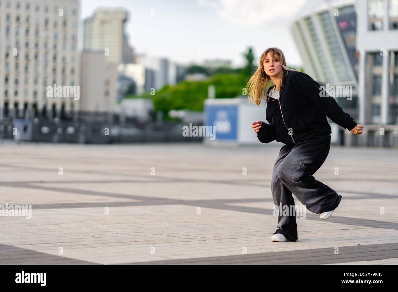 A young woman wears oversized clothes and dances hip-hop Stock Photo ...