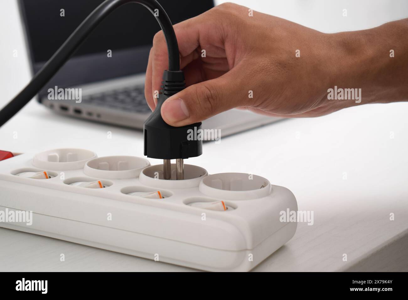 Hand holding electric plug, Multiple socket with connected plugs ...