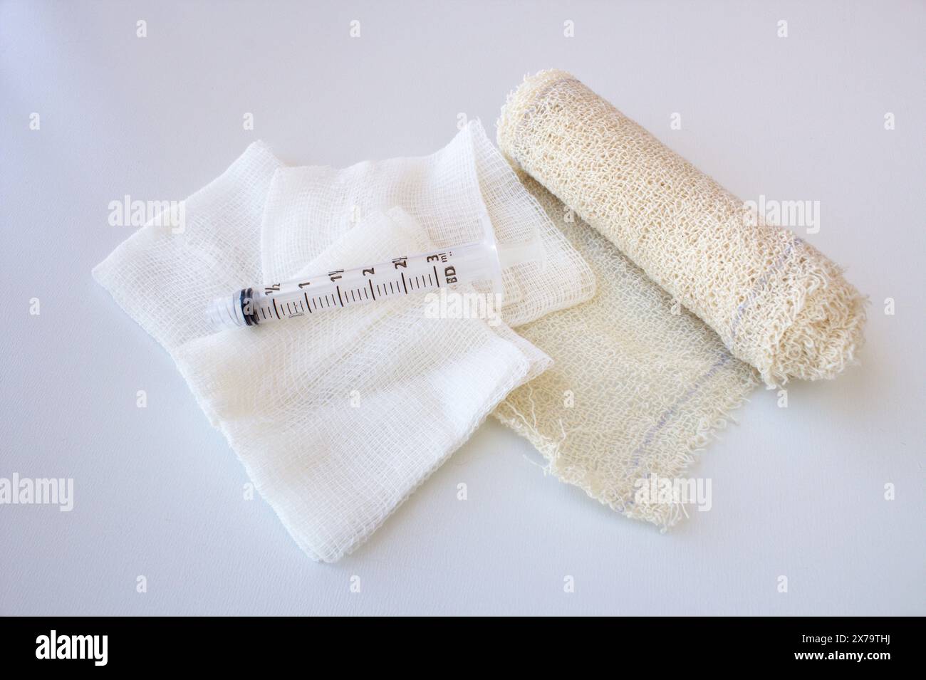 Hospital bandages and syringe on white background Stock Photo - Alamy
