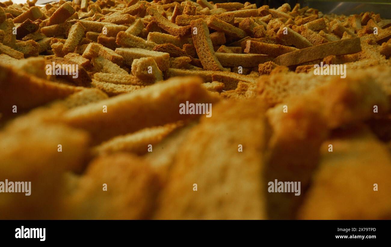 Fresh bread crackers on the conveyor. The process of making bread ...