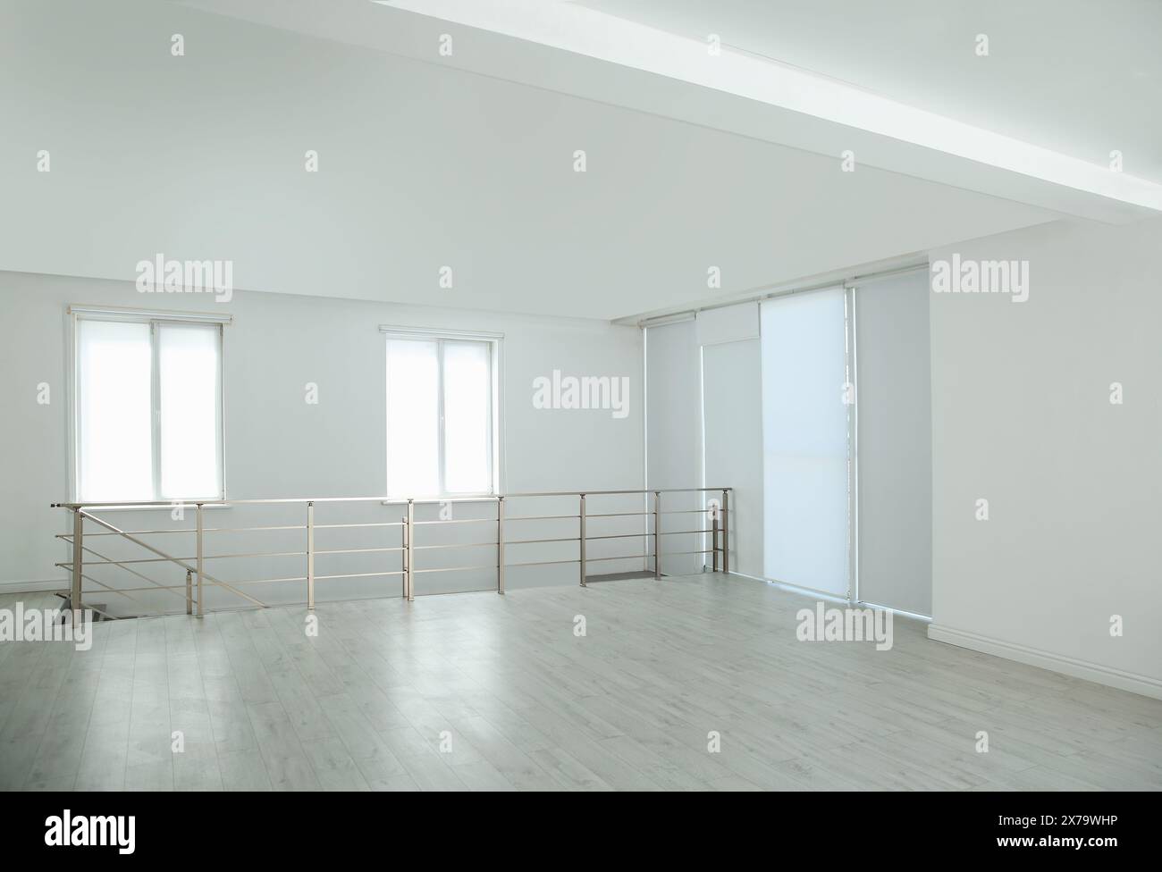 Large empty hall with windows and railings Stock Photo - Alamy