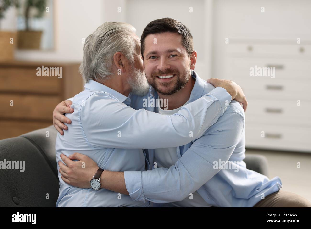 Happy son and his dad hugging at home Stock Photo - Alamy