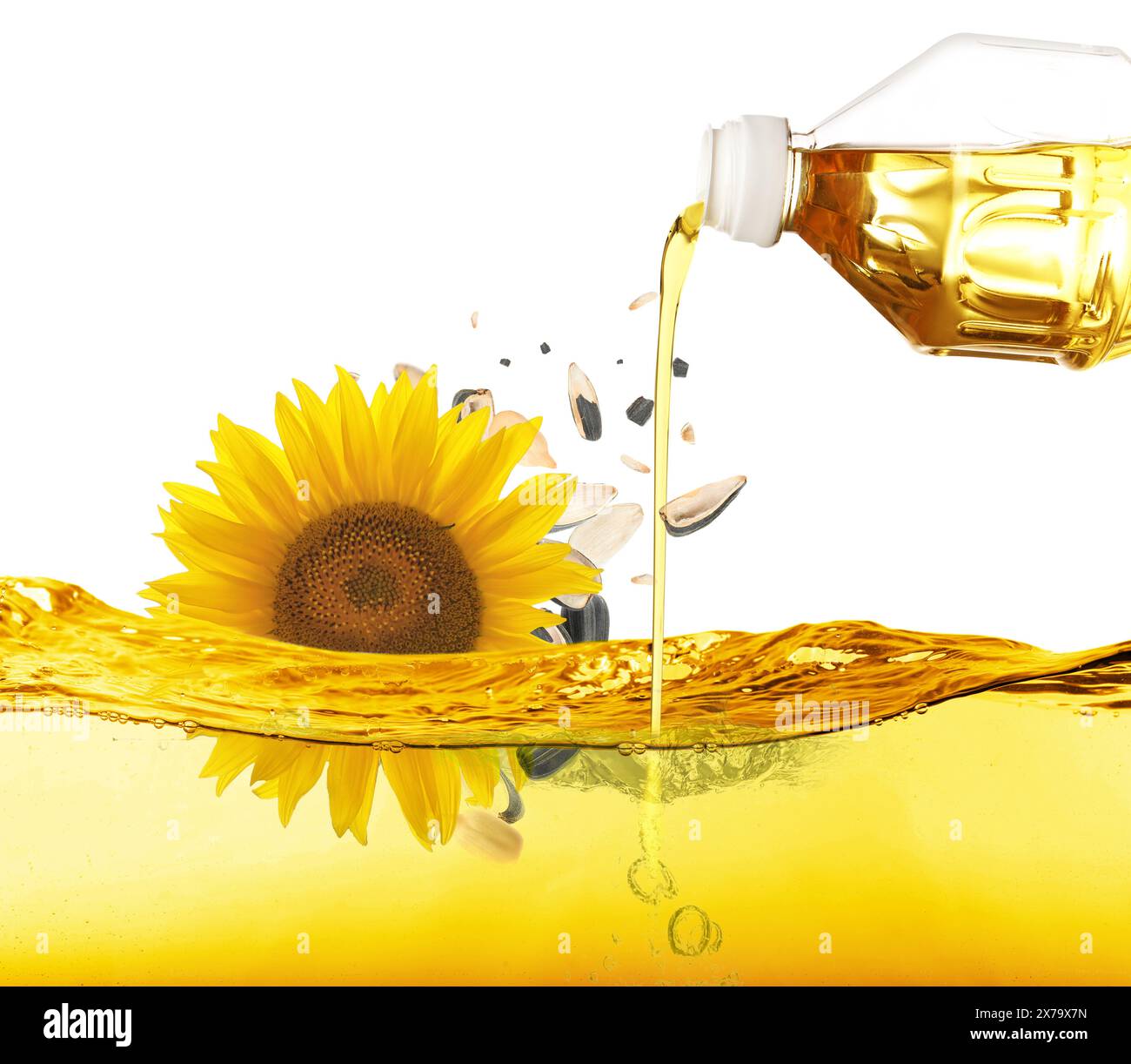 Pouring sunflower oil and falling seeds on white background Stock Photo ...