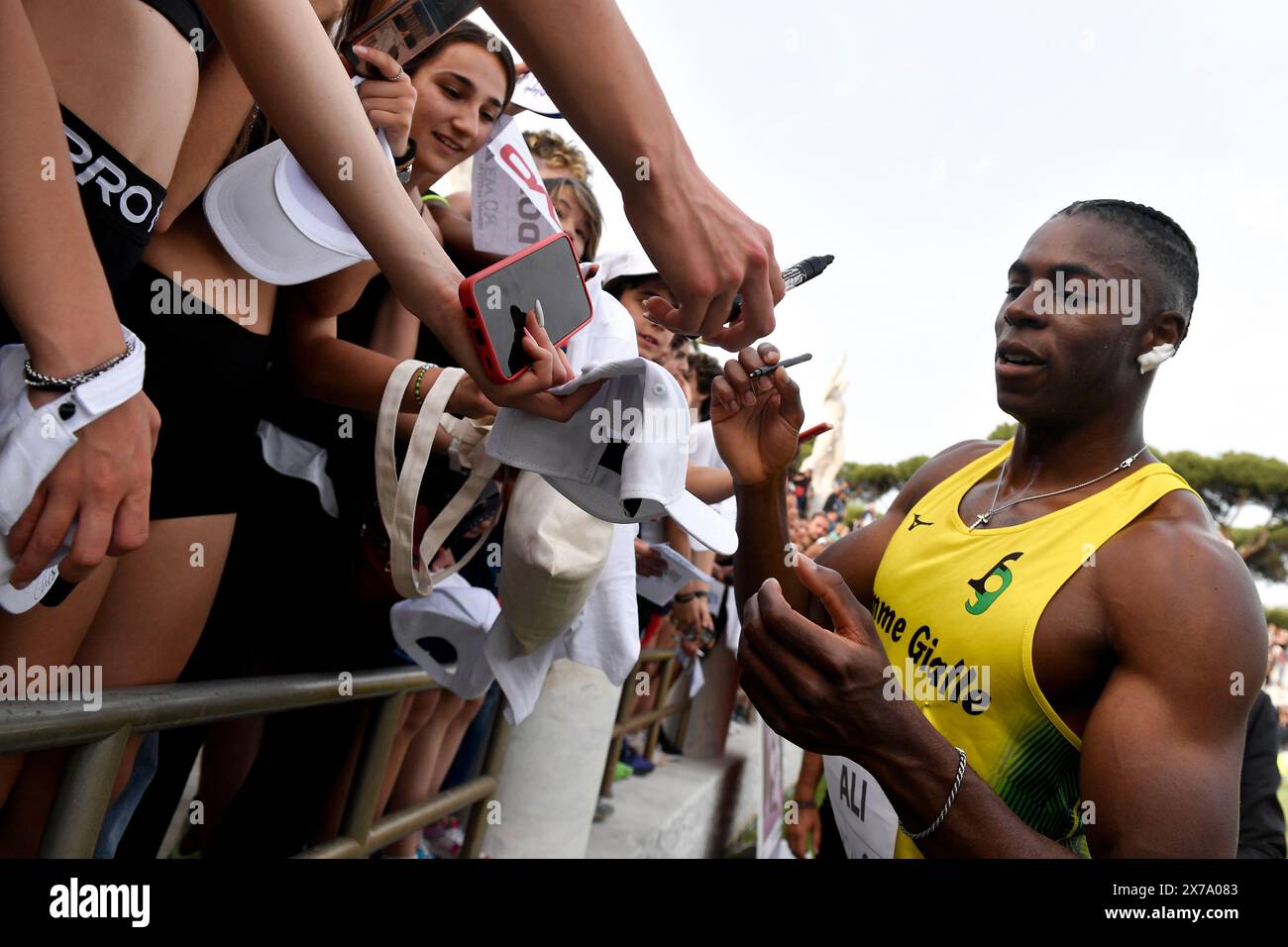 Chituru Ali of Italy signs autographs after competing in the 100m ...
