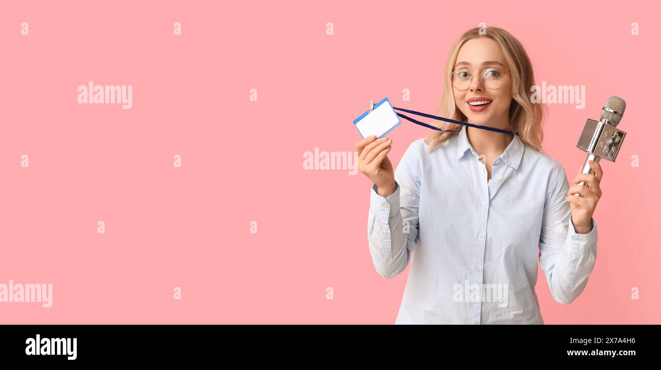 Portrait of female journalist with microphone and ID badge on pink ...