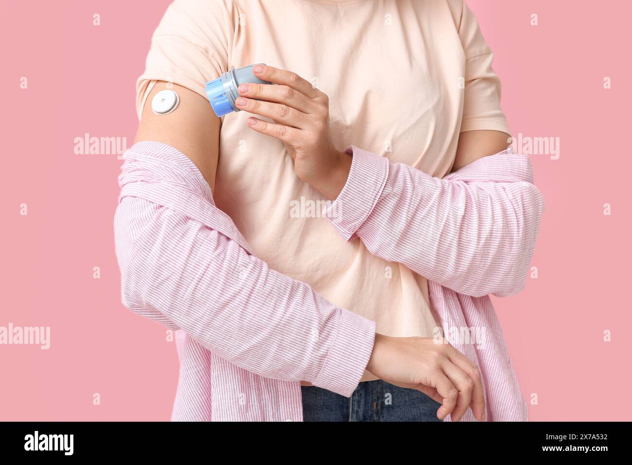 Woman with glucose sensor for measuring blood sugar level and ...