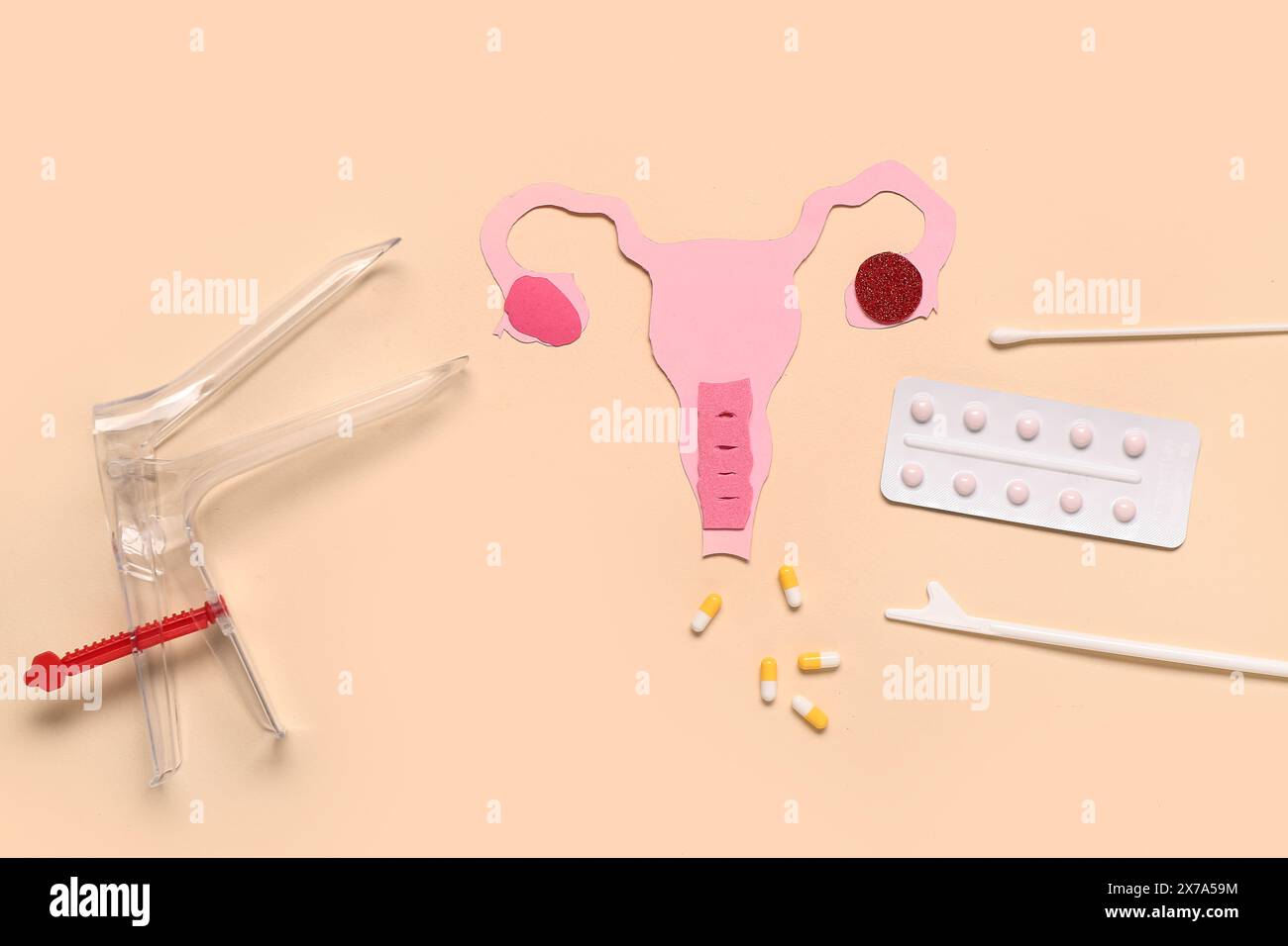Paper uterus with pills, pap smear test tools and gynecological ...