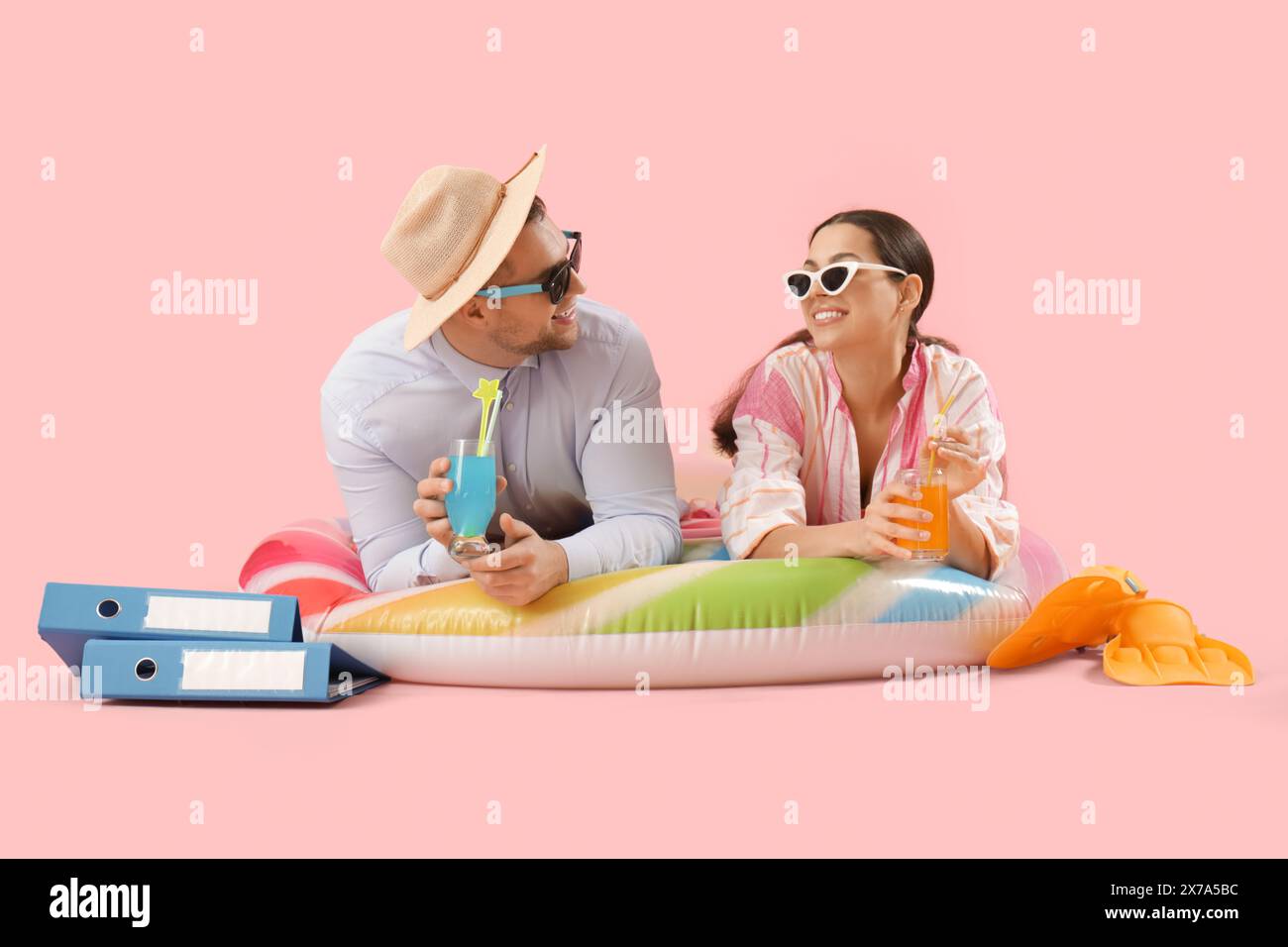 Happy office workers in sunglasses with cocktails lying on inflatable ...