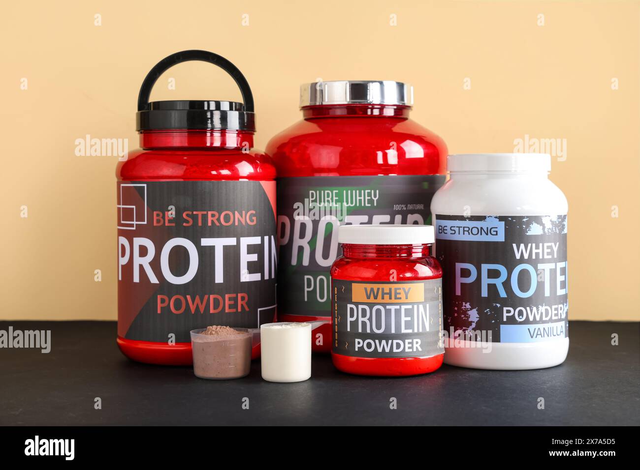 Different bottles with protein powder and scoops on dark table Stock ...