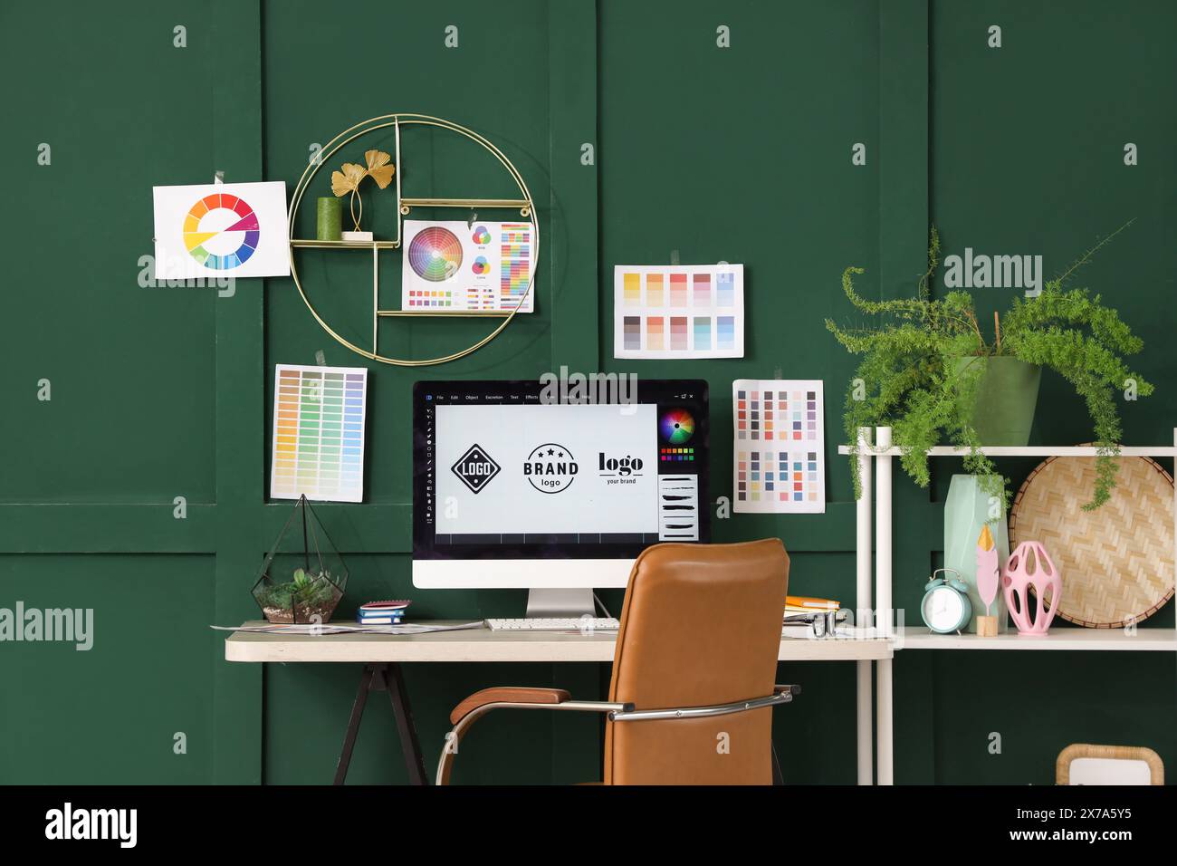 Graphic designer's workplace with computer monitor and color palettes ...
