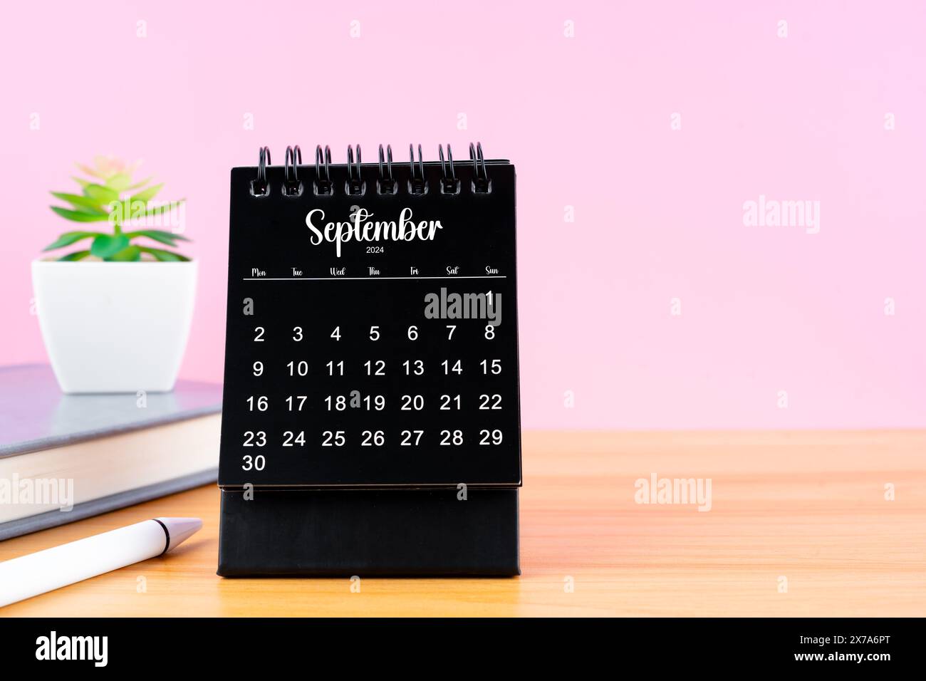 September Mini desk calendar for 2024 year on worktable with pink color ...