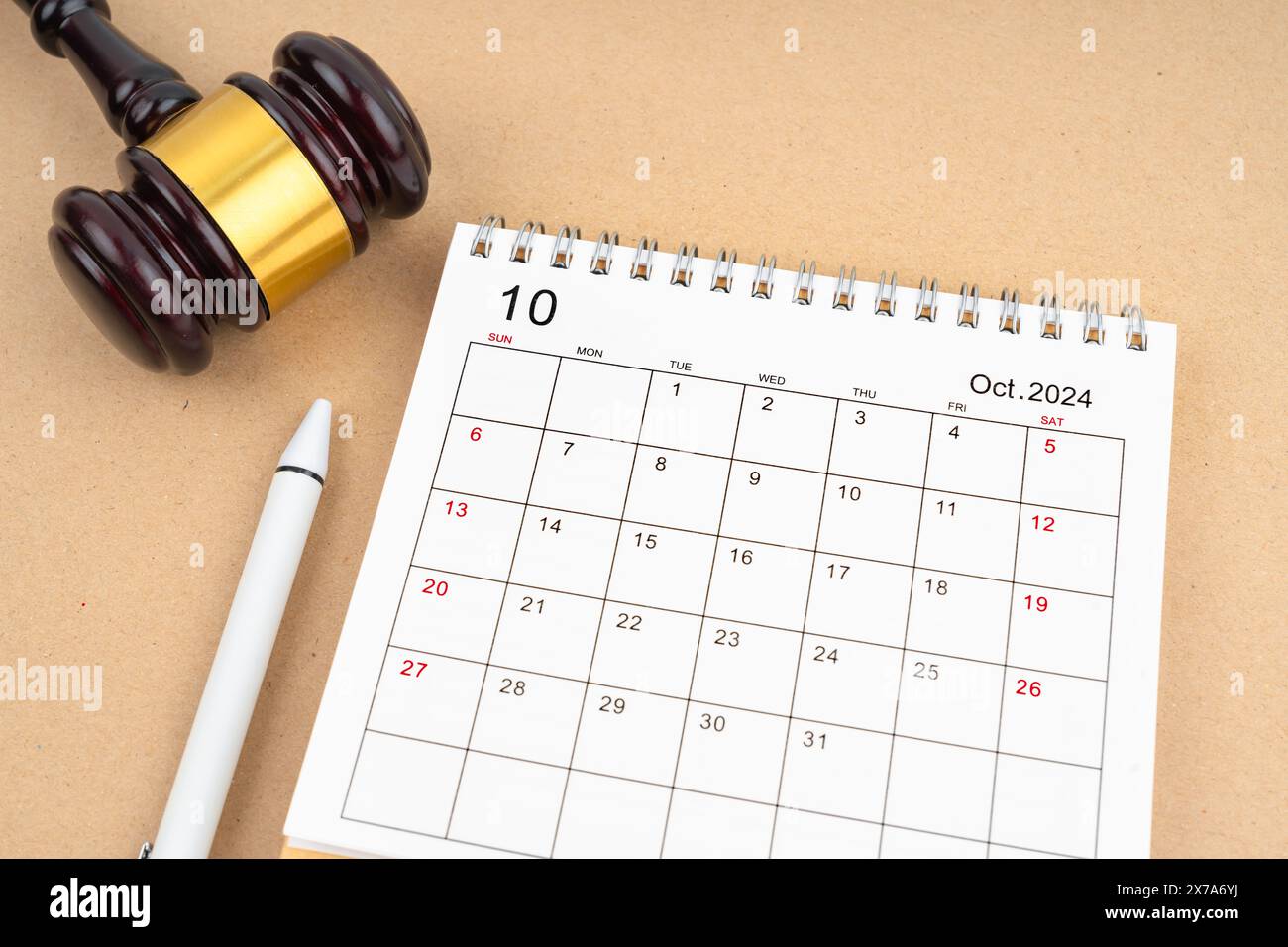 Desk calendar for October 2024 and judge's gavel on brown color ...