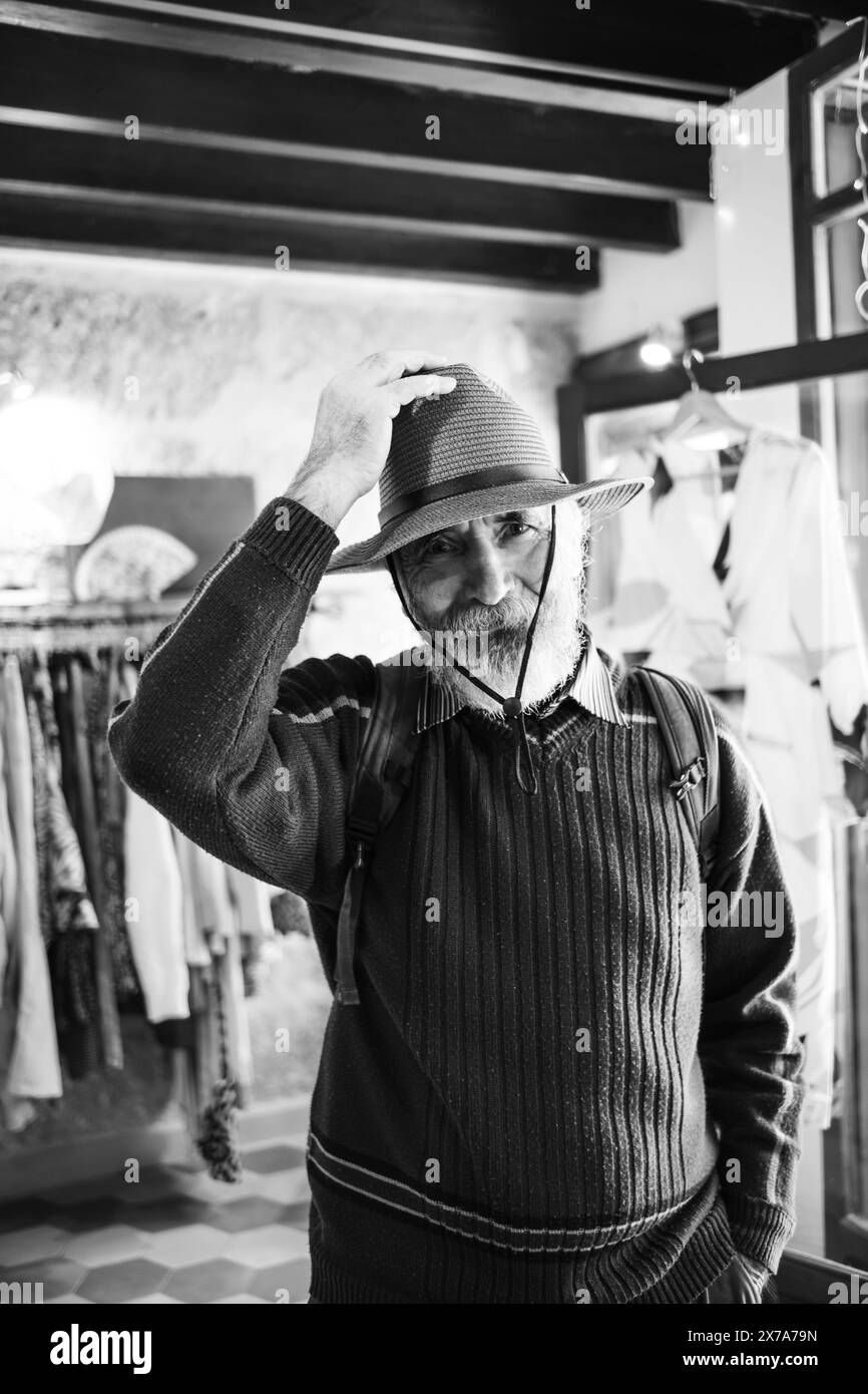 Bearded Old Man in a Hat. An old traveler with a backpack and a ...