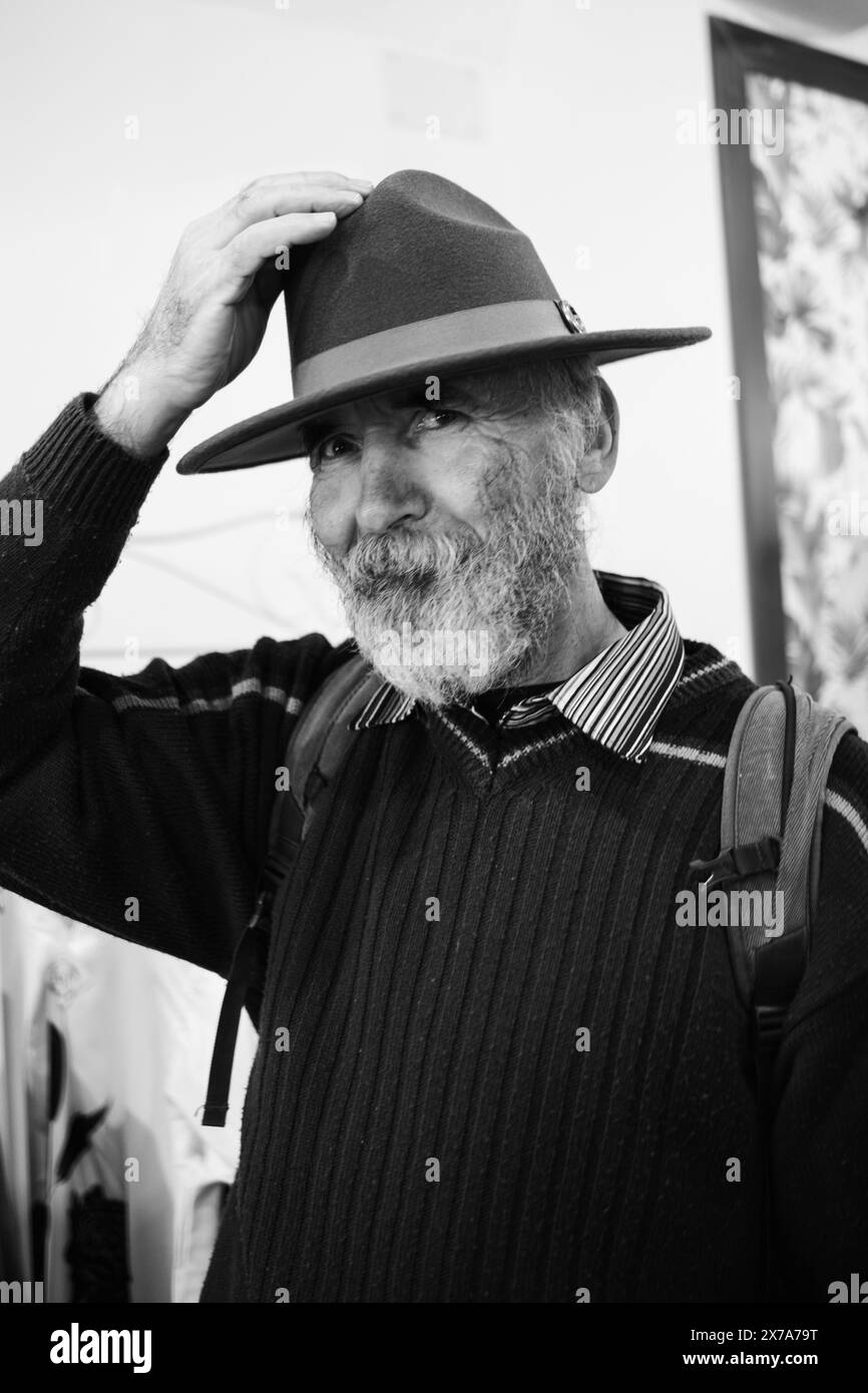 Bearded Old Man in a Hat. An old traveler with a backpack and a ...