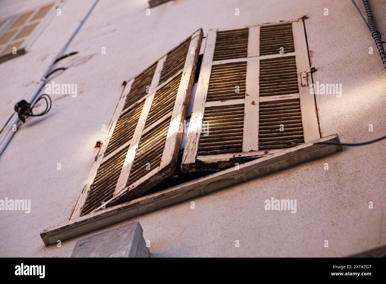 Wooden shutters with red paint residue. Peeling wooden shutters close ...