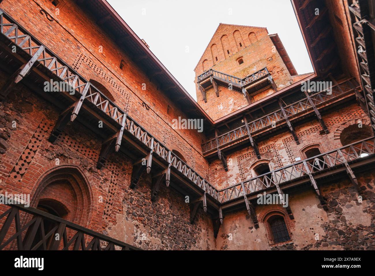 Visitors explore Trakai Island Castle, Lithuania. With its wooden ...