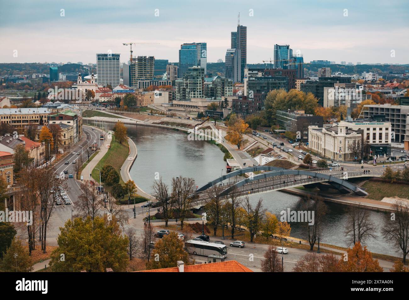 the Neris river flows through Vilnius city center on a grey autumn day ...