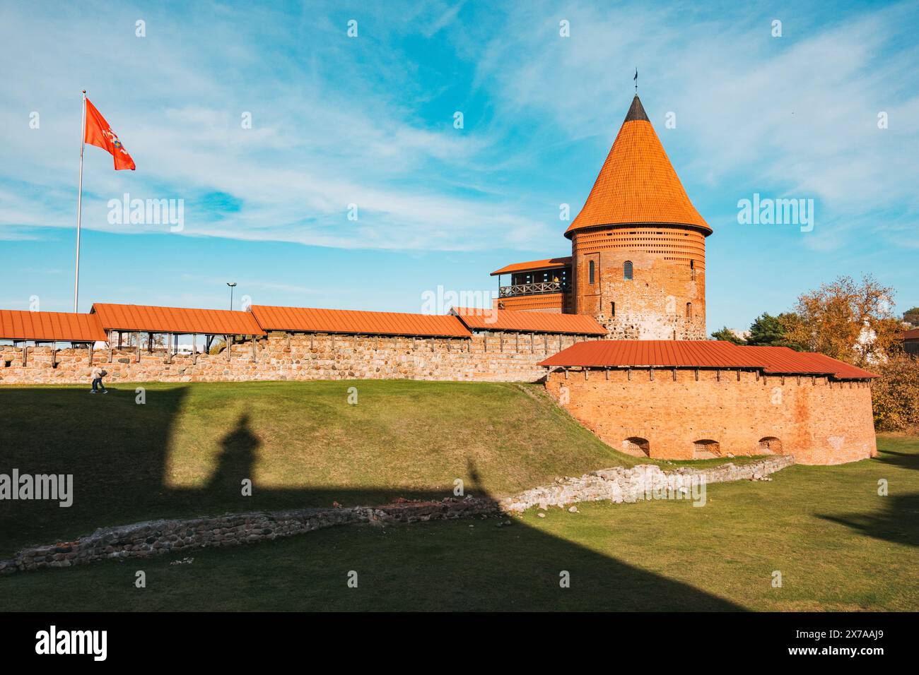 Kaunas Castle showcases its striking red towers, vibrant autumn foliage ...