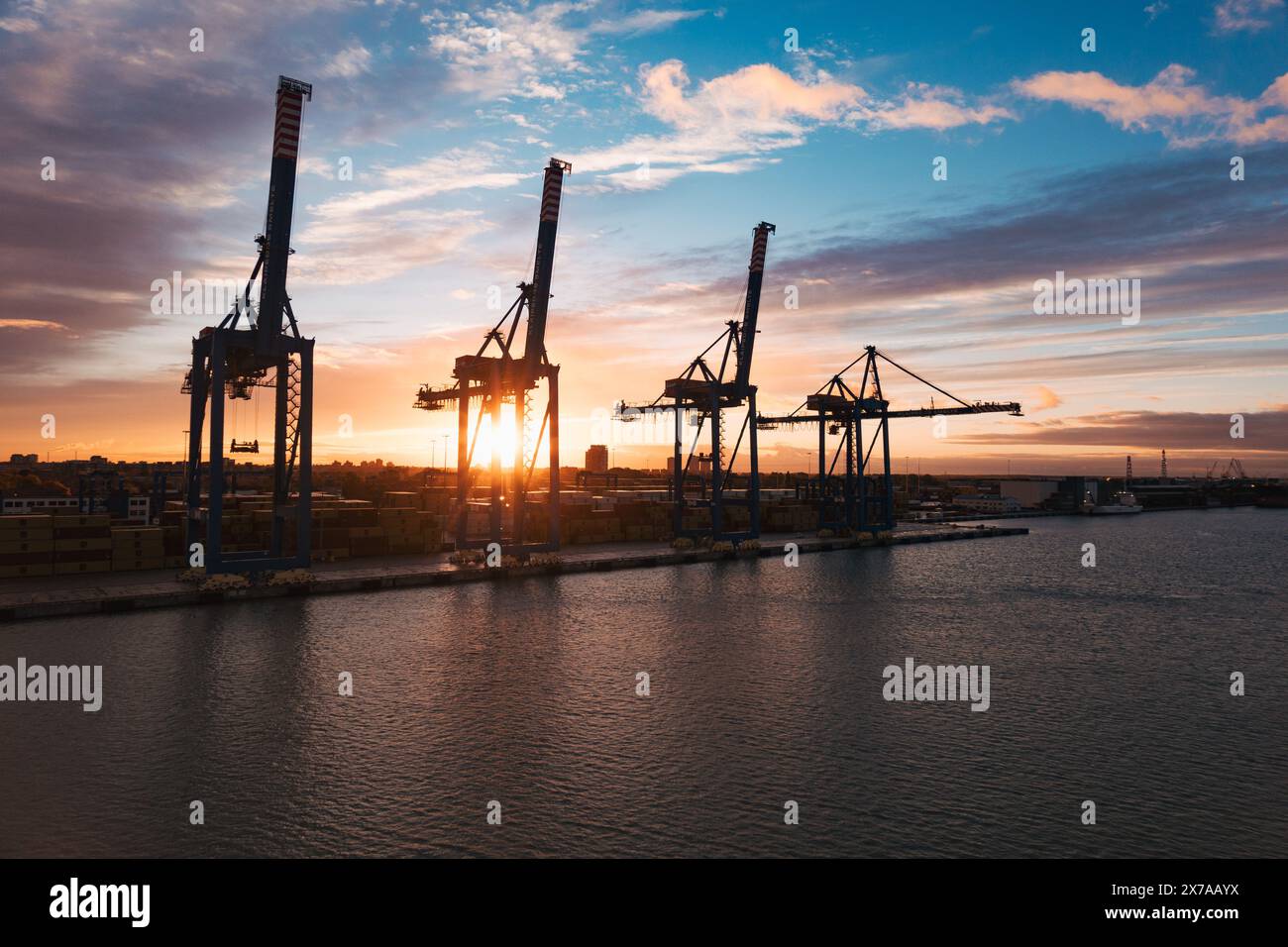 silhouettes of shipping container cranes at Klaipėda Port, Lithuania ...