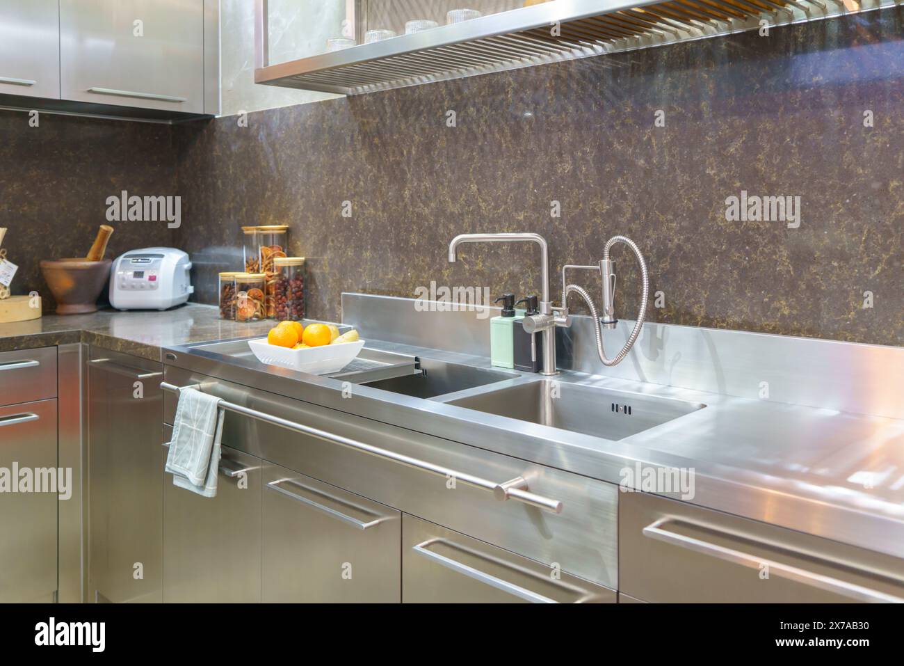 Interior shot of a modern kitchen. Featuring a sleek stove, a stylish ...