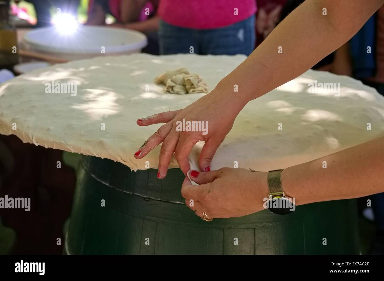 Preparing soparnik - traditional Croatian food with dough, vegetables ...