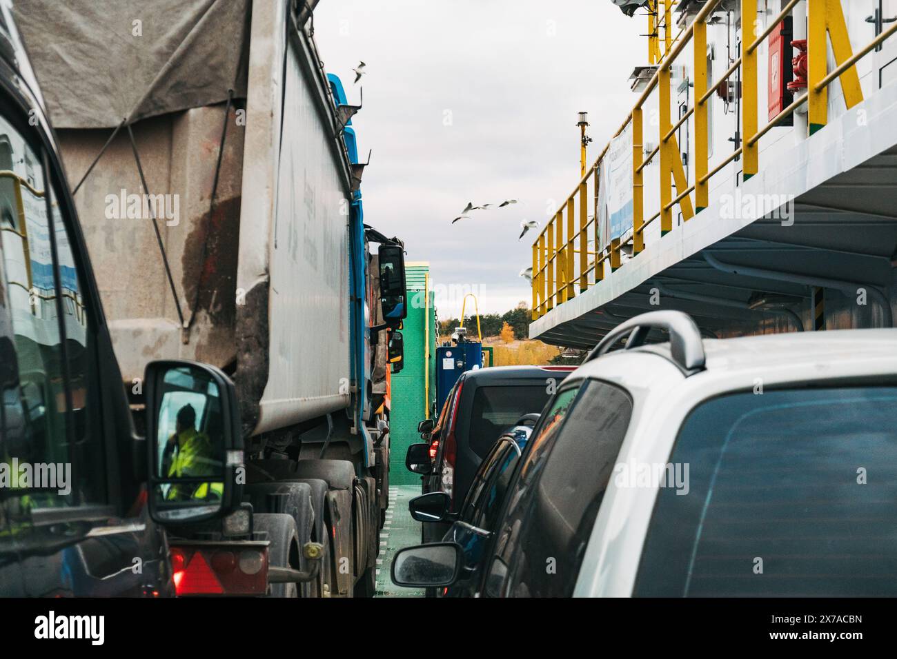 cars, a van and a truck on a ferry deck from the Curonian Spit to ...