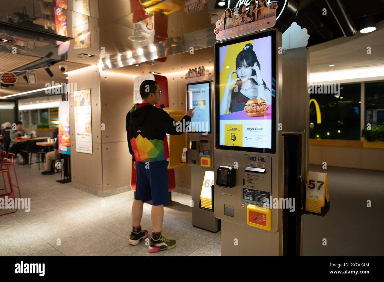 HONG KONG, CHINA - DECEMBER 04, 2023: man use self-service ordering kiosk at McDonald's fast ...