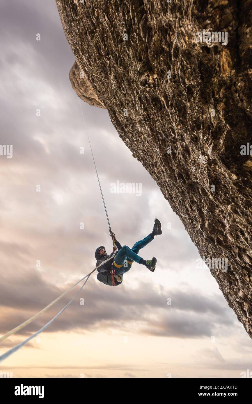 boy climbing on the mountain, boy rappelling on the mountain, enjoy ...