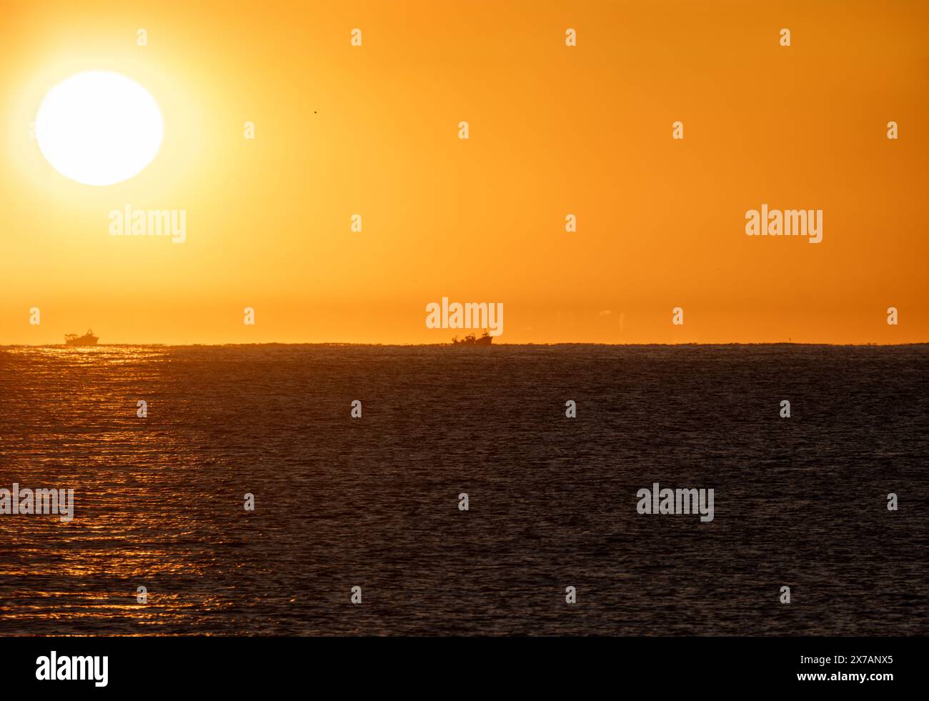 Yellow dawn sun emerging from the retro Mediterranean Sea horizon ...