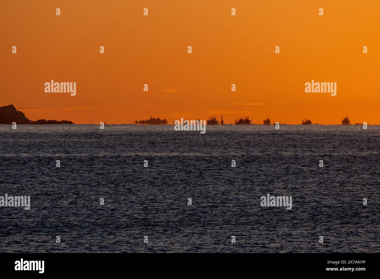Fishing boats on the horizon line of the Mediterranean Sea heading out ...