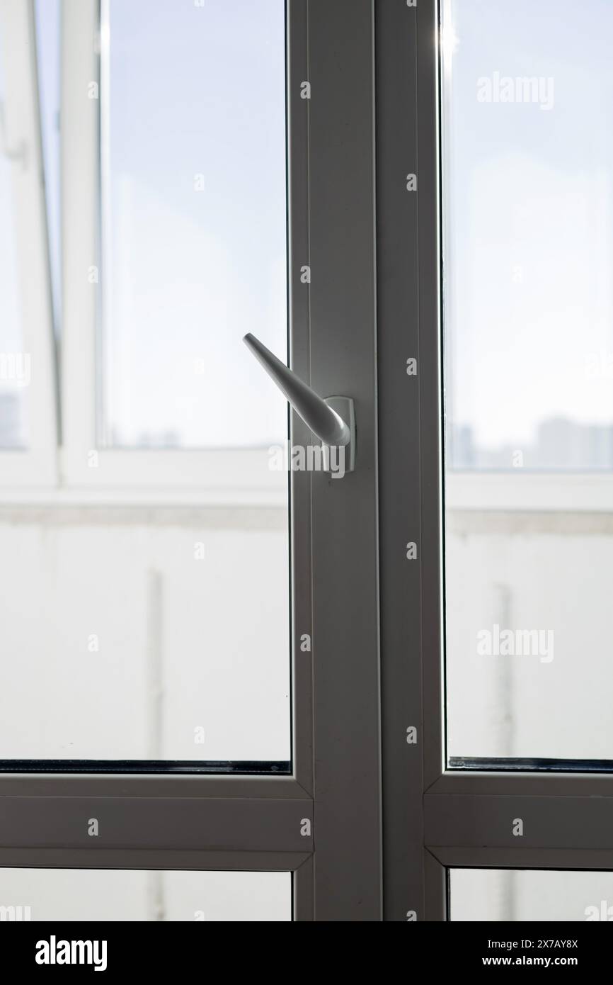 white plastic pvc window with frame and handle. House improvement and ...