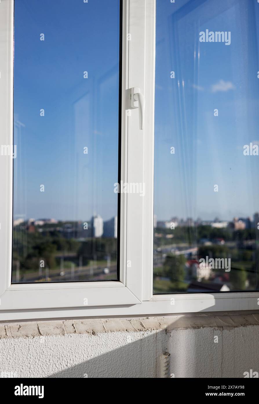 new modern white plastic pvc window with frame and handle and view on ...