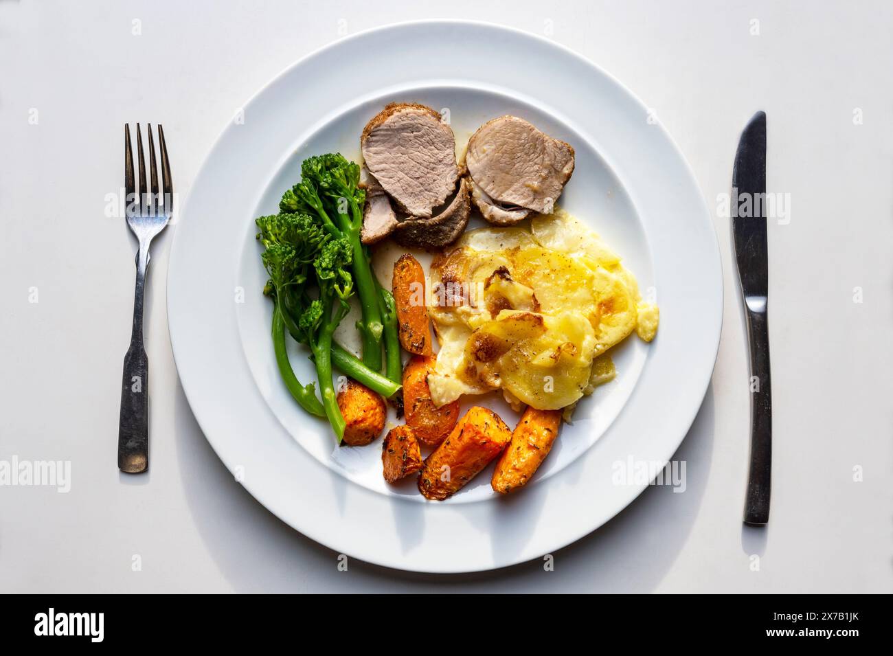 Pork medallions broccoli carrots and potatoes Stock Photo - Alamy
