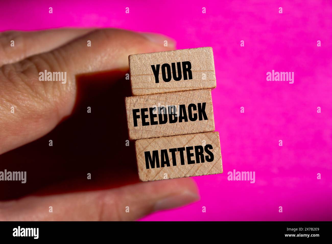 Your feedback matters words written on wooden blocks with pink ...