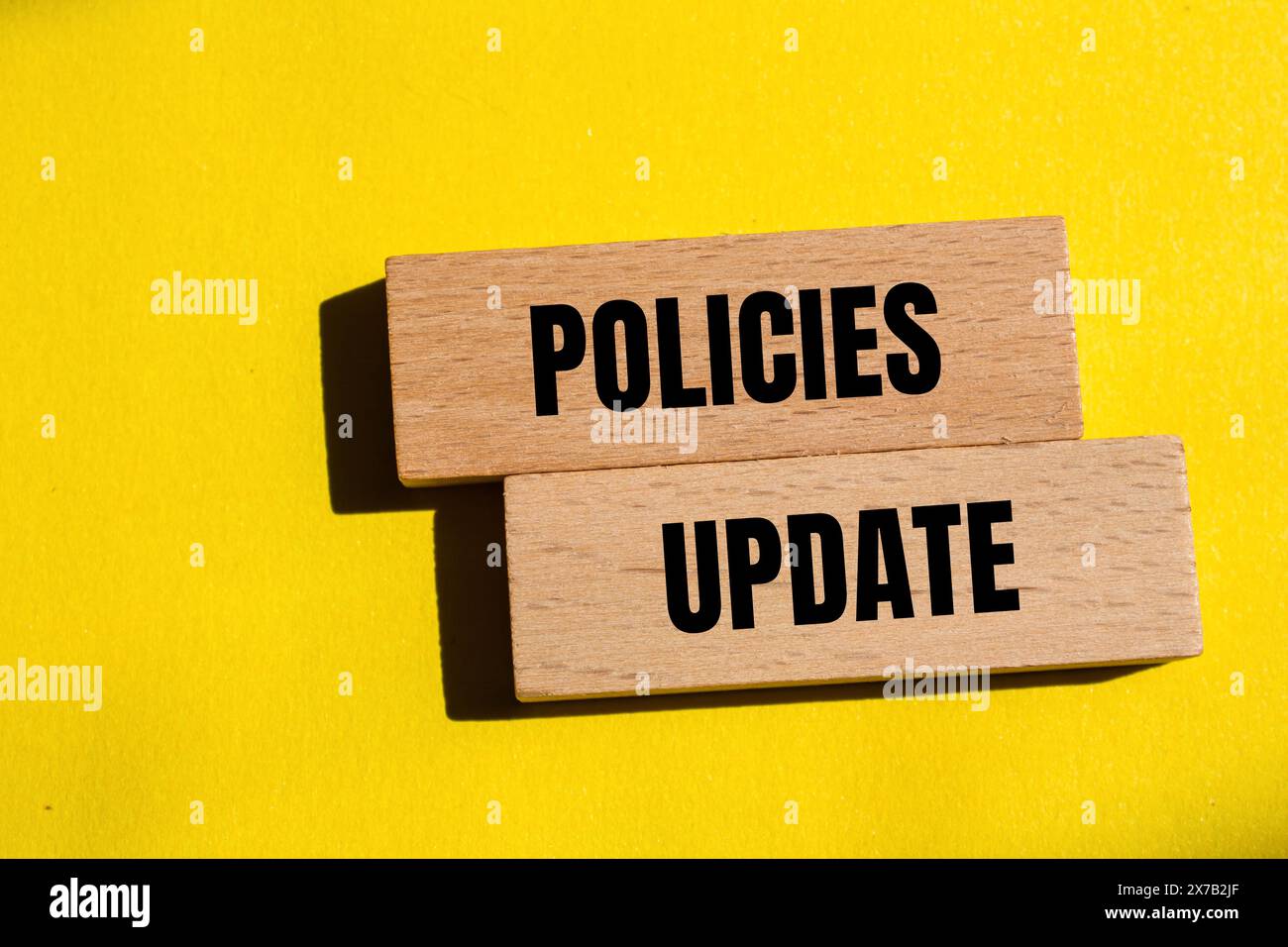 Policies update words written on wooden blocks with yellow background ...