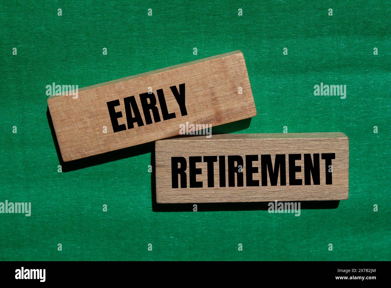Early retirement words written on wooden blocks with green background ...